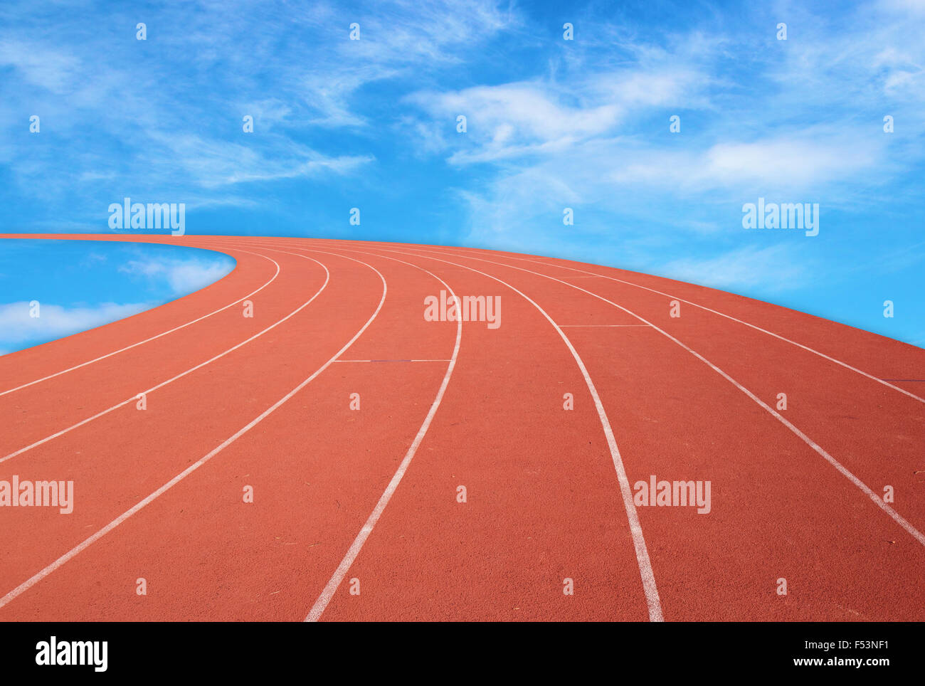 empty outdoor running track with blue sky background Stock Photo - Alamy