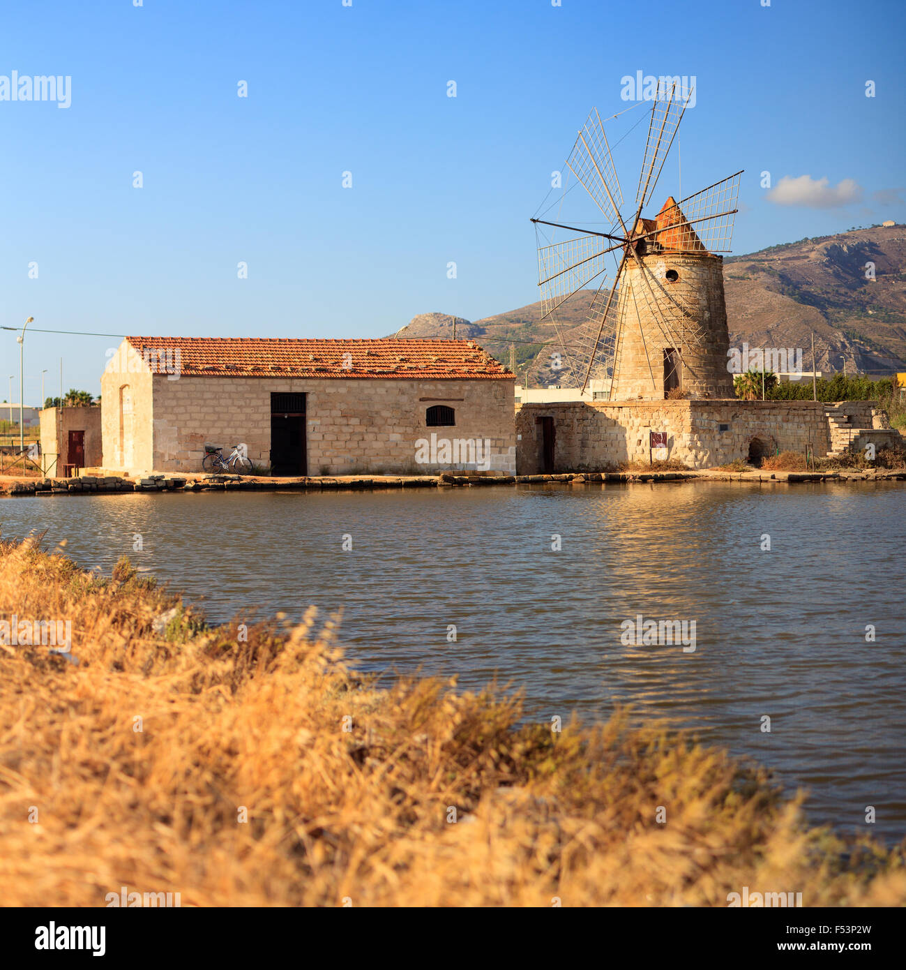 View of windmill in the salt pans, Trapani. Sicily Stock Photo - Alamy
