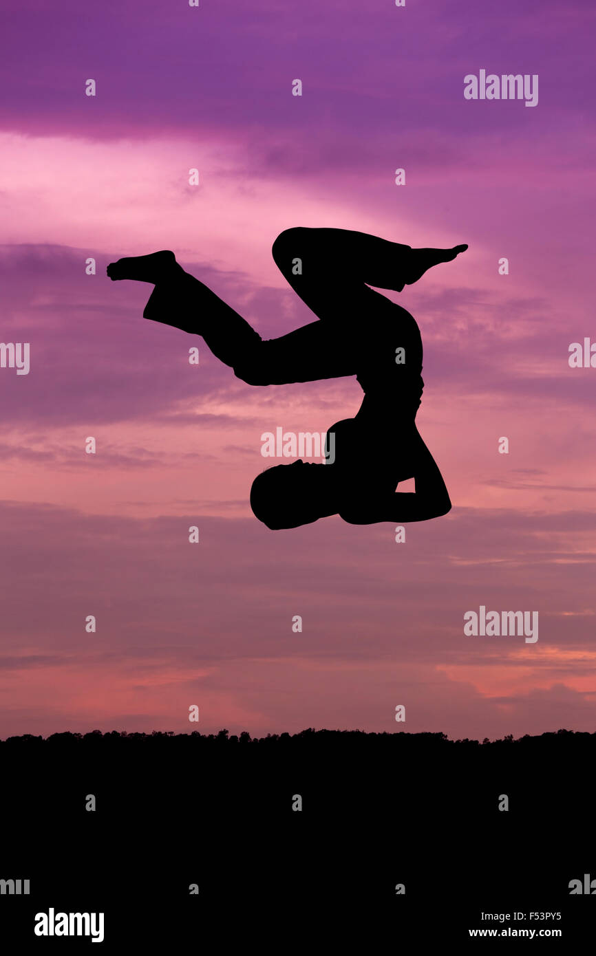 Silhouette of woman jumping at sunset Stock Photo - Alamy