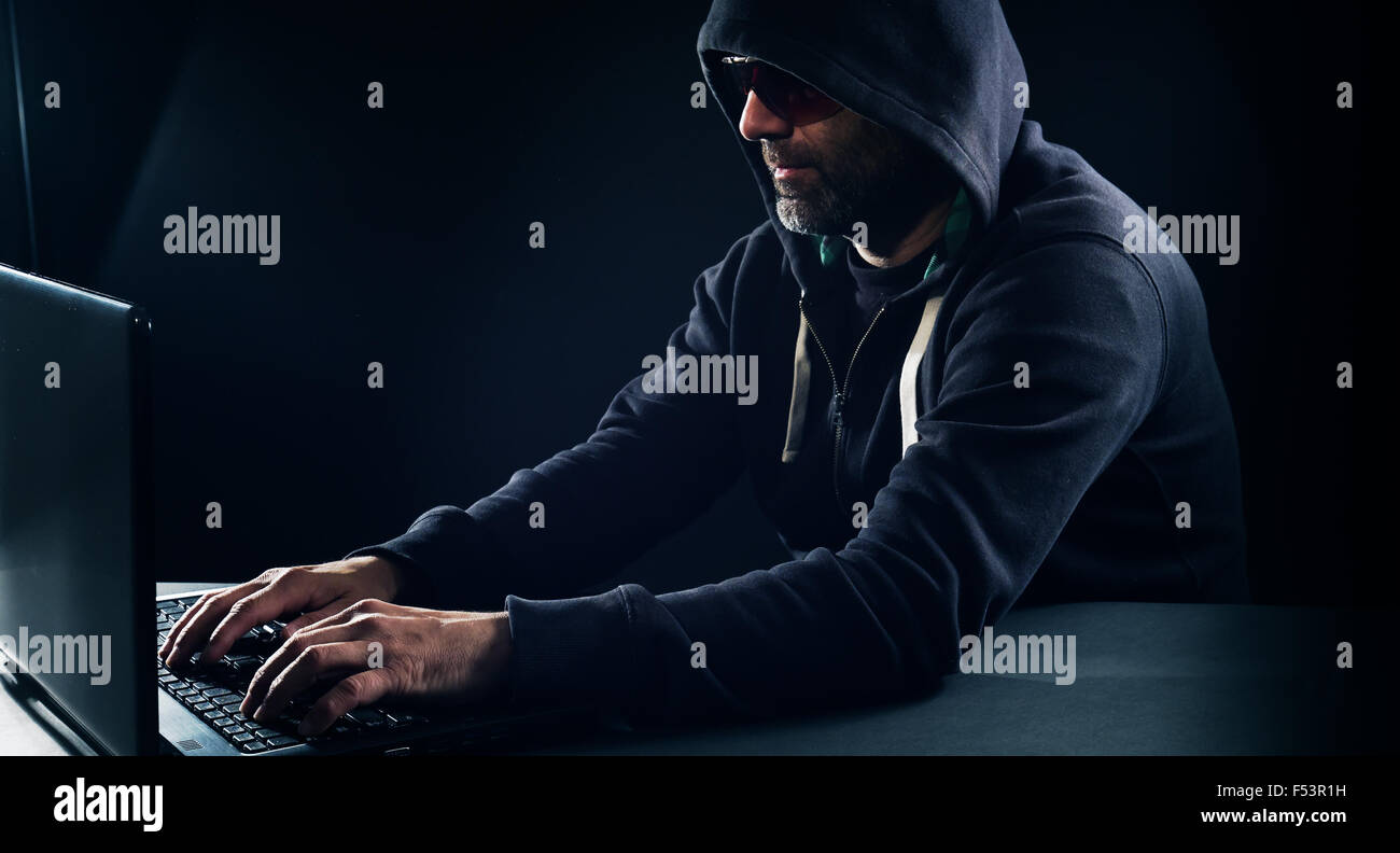 Hacker typing on computer keyboard, black copy-space Stock Photo - Alamy