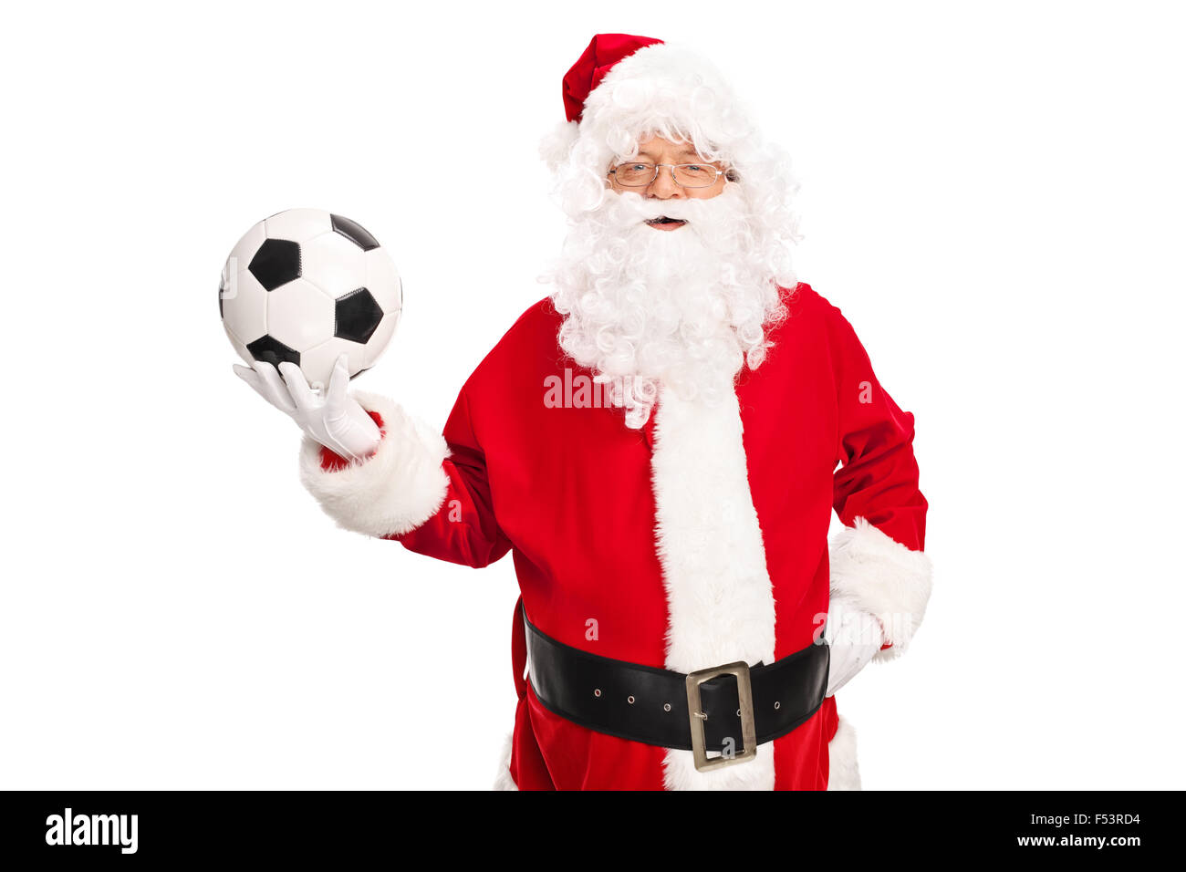 Studio shot of Santa Claus holding a football and looking at the camera ...