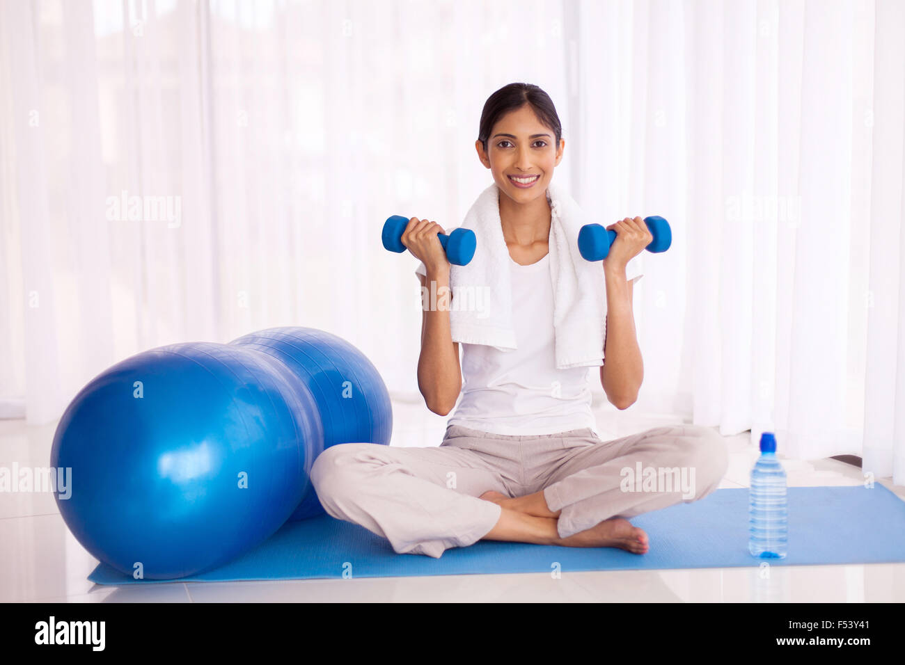 fit Indian girl exercising with dumbbells at home Stock Photo - Alamy
