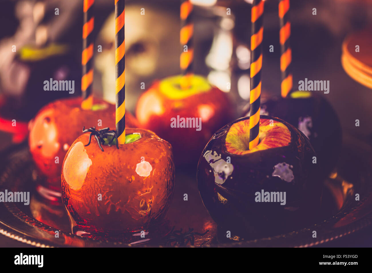 Table with colored candy apples and cake for Halloween party Stock ...