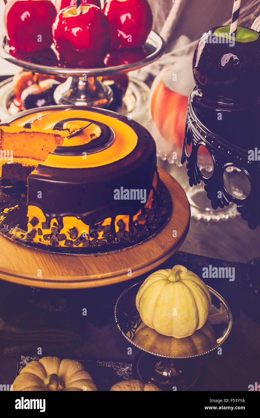 Table with colored candy apples and cake for Halloween party Stock ...