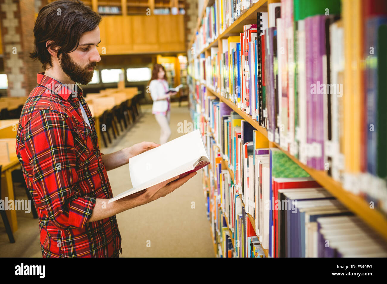 Serious woman thinking in library hi-res stock photography and images ...