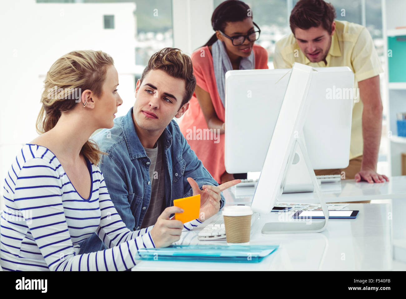 Creative business team working hard together on pc Stock Photo - Alamy