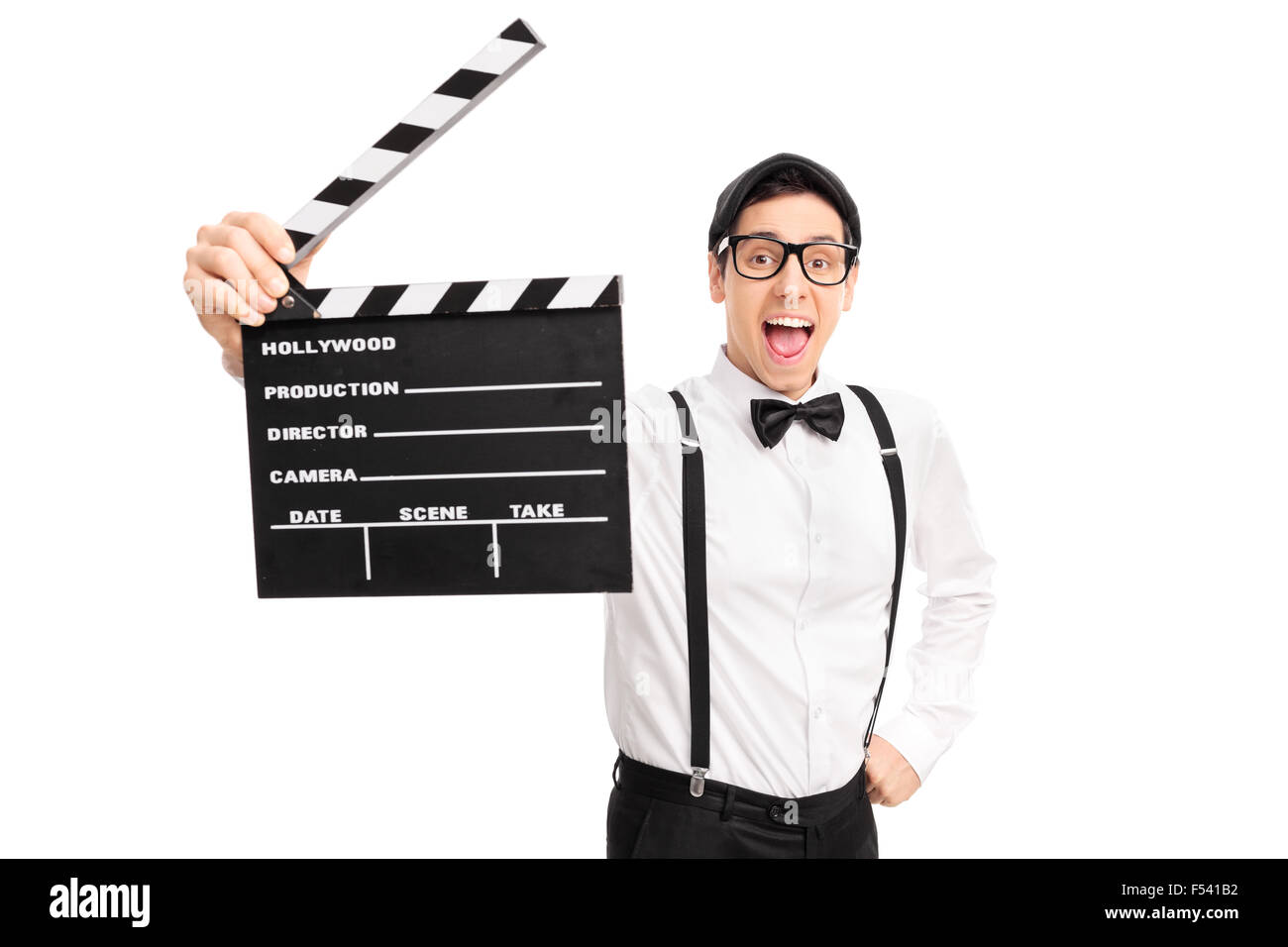 Excited young movie director holding a clapperboard and looking at the ...
