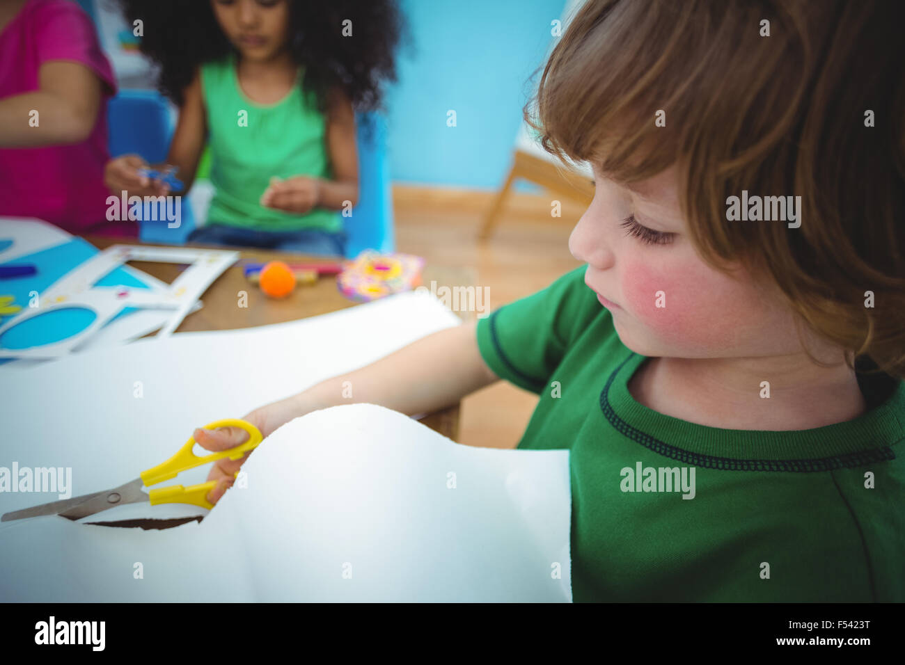 Happy kids doing arts and crafts together Stock Photo - Alamy