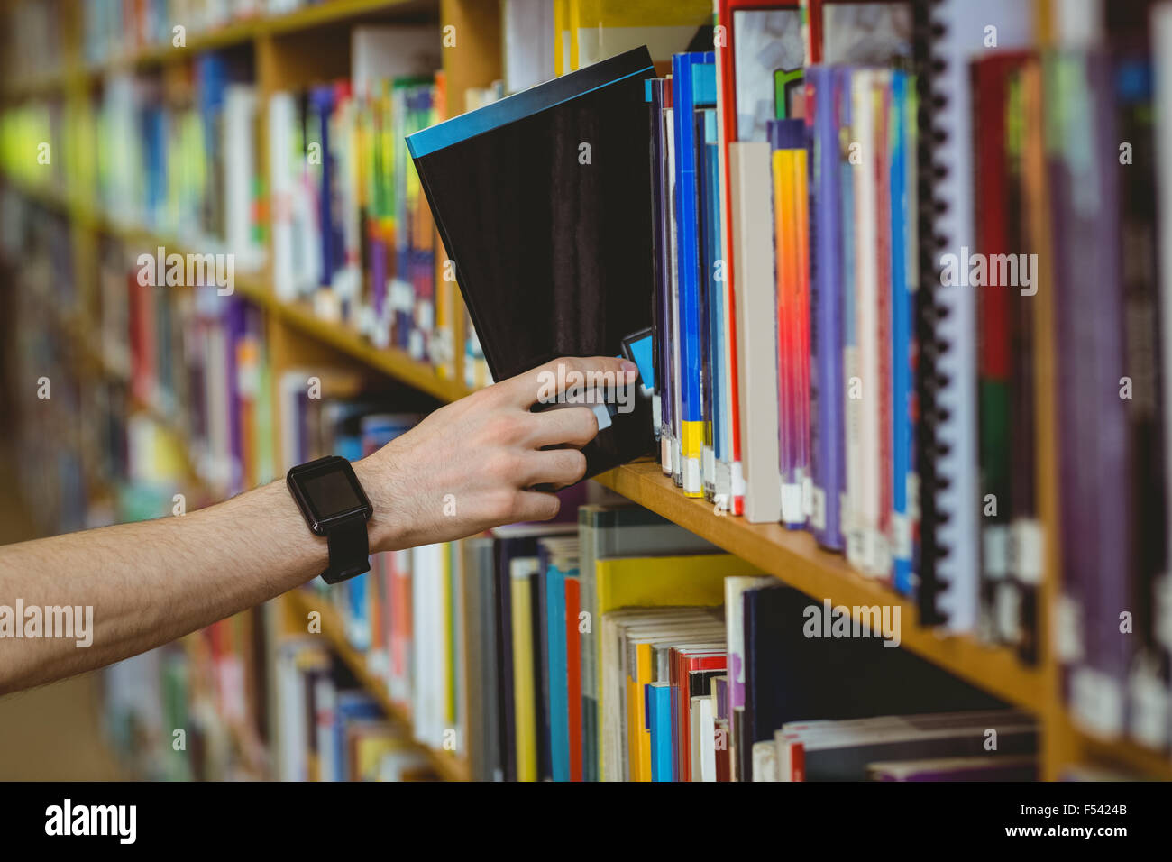 Student wearing a smart watch in library Stock Photo - Alamy
