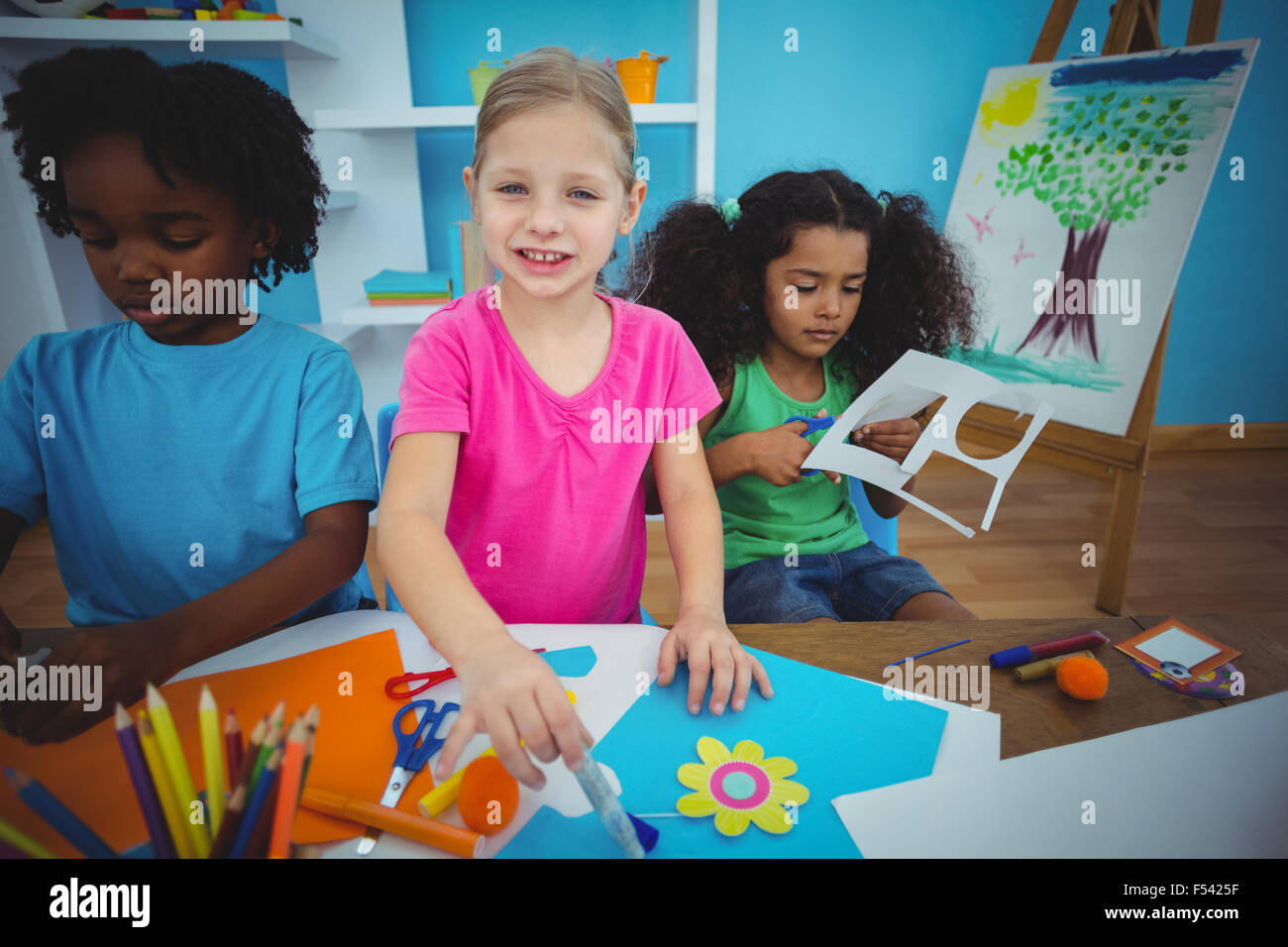 Happy kids doing arts and crafts together Stock Photo - Alamy