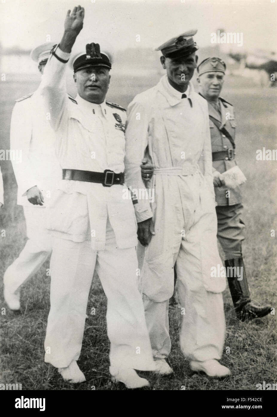 The Italian dictator Benito Mussolini in his white uniform salutes ...