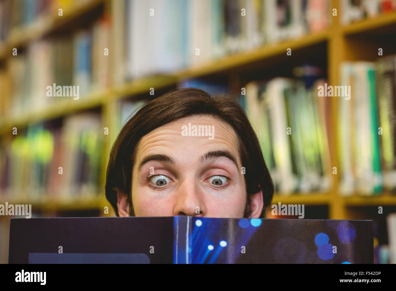 Student messing in the library Stock Photo - Alamy