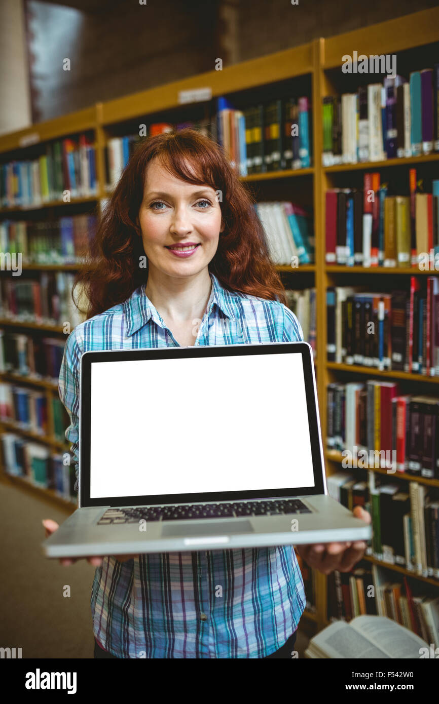 Mature student in library using laptop Stock Photo - Alamy
