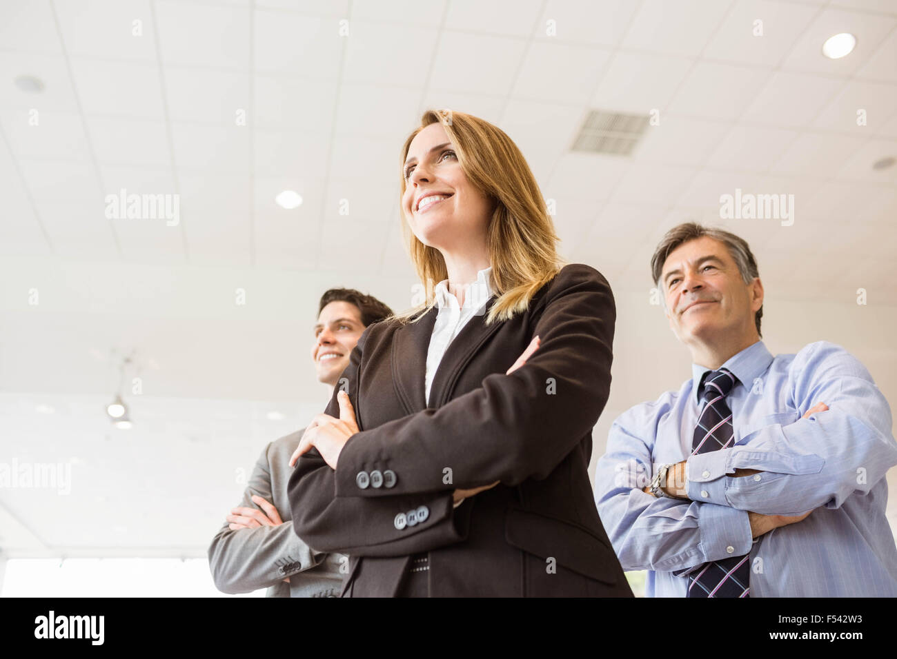 Group of smiling business team standing together Stock Photo - Alamy