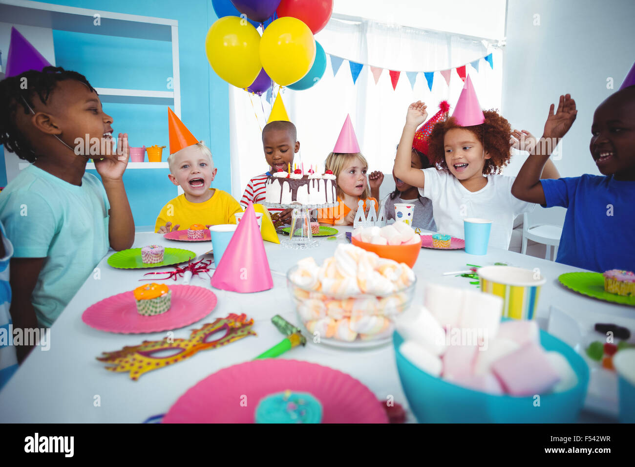Excited kids enjoying a birthday party Stock Photo - Alamy