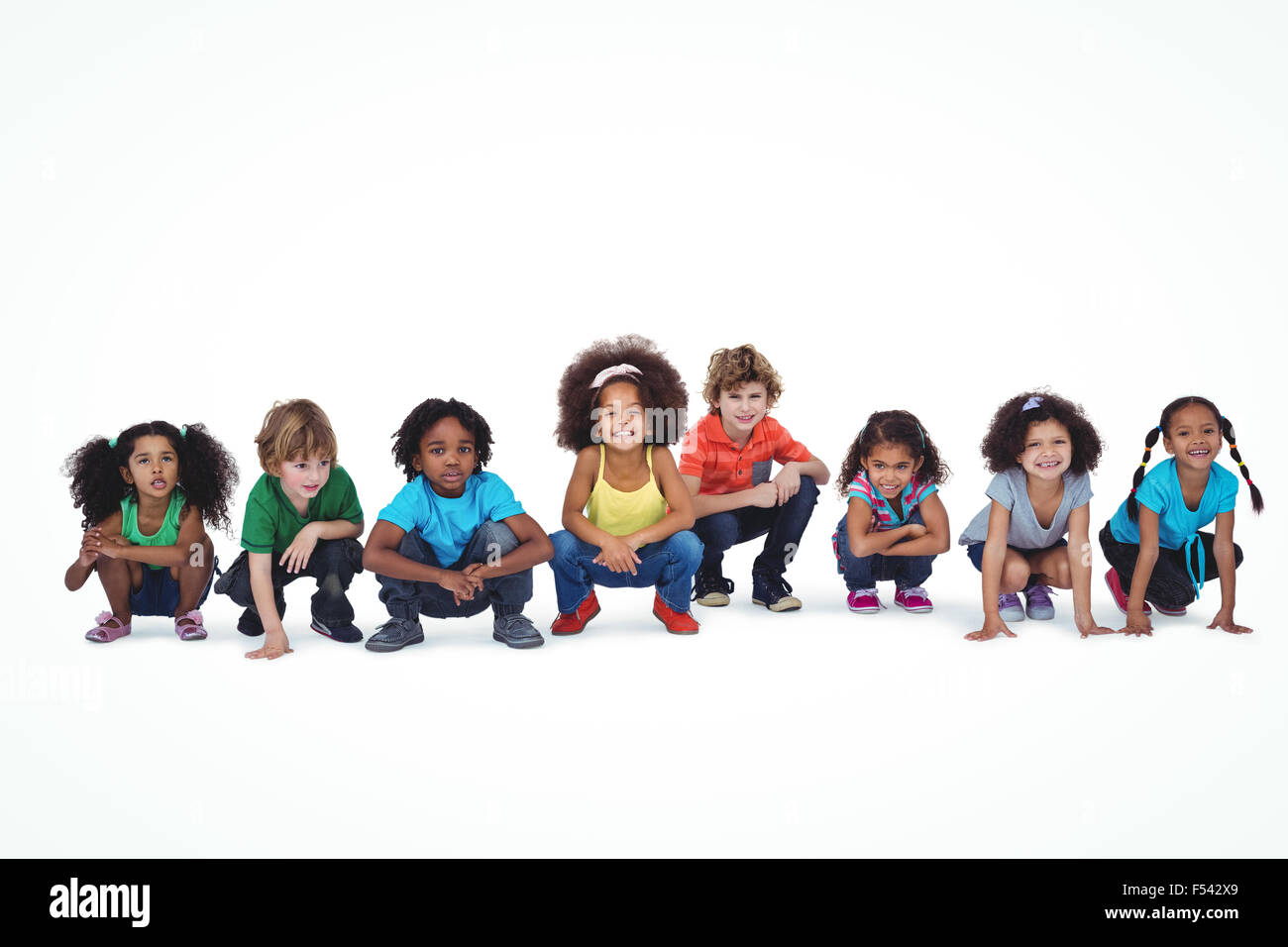 A row of children crouching down together Stock Photo - Alamy