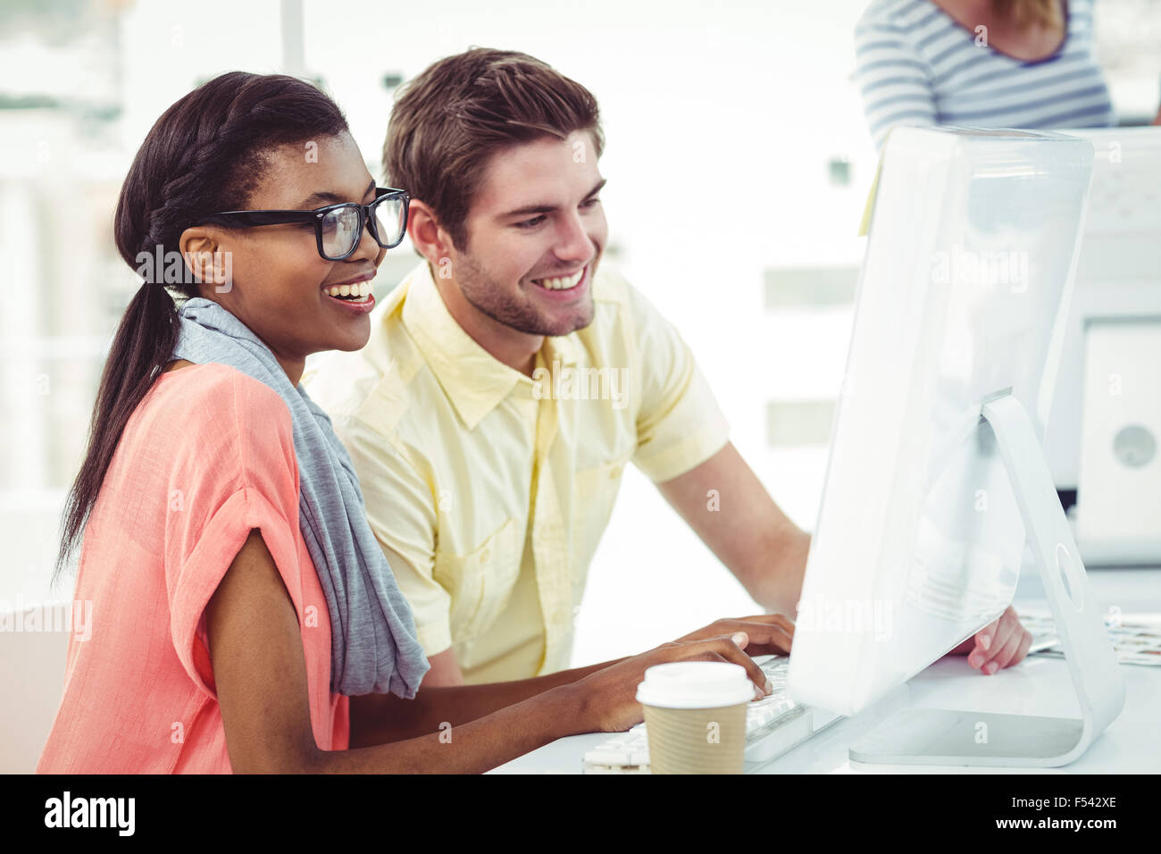Creative business team working hard together on pc Stock Photo - Alamy