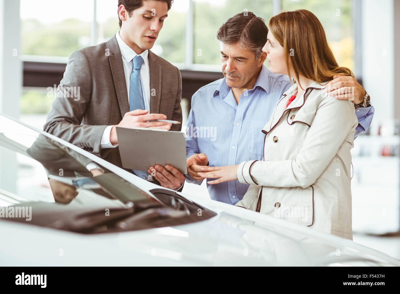 Smiling businessman presenting a car Stock Photo - Alamy
