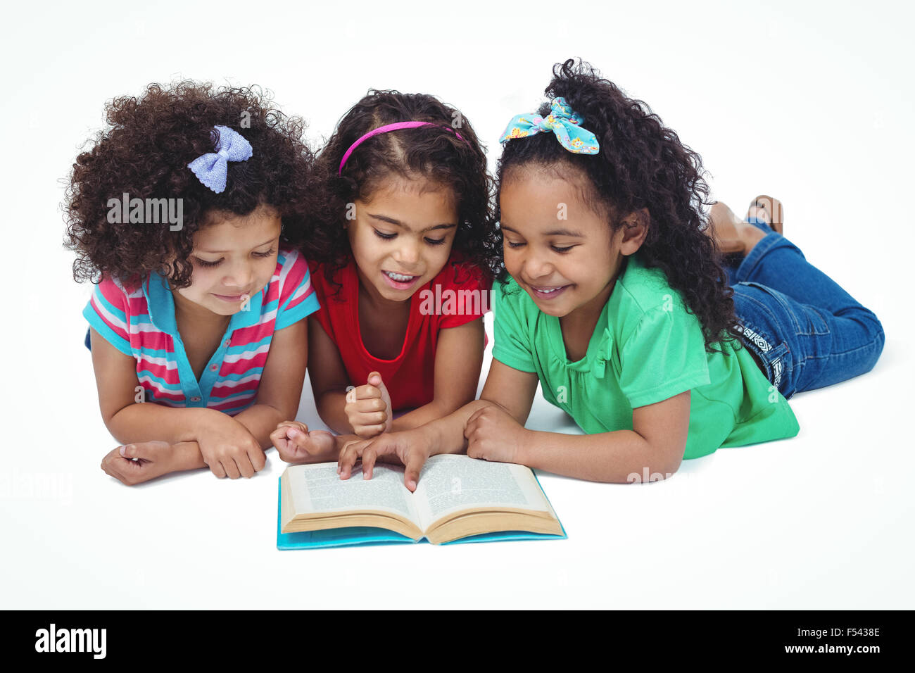 Three girls reading a book Stock Photo - Alamy