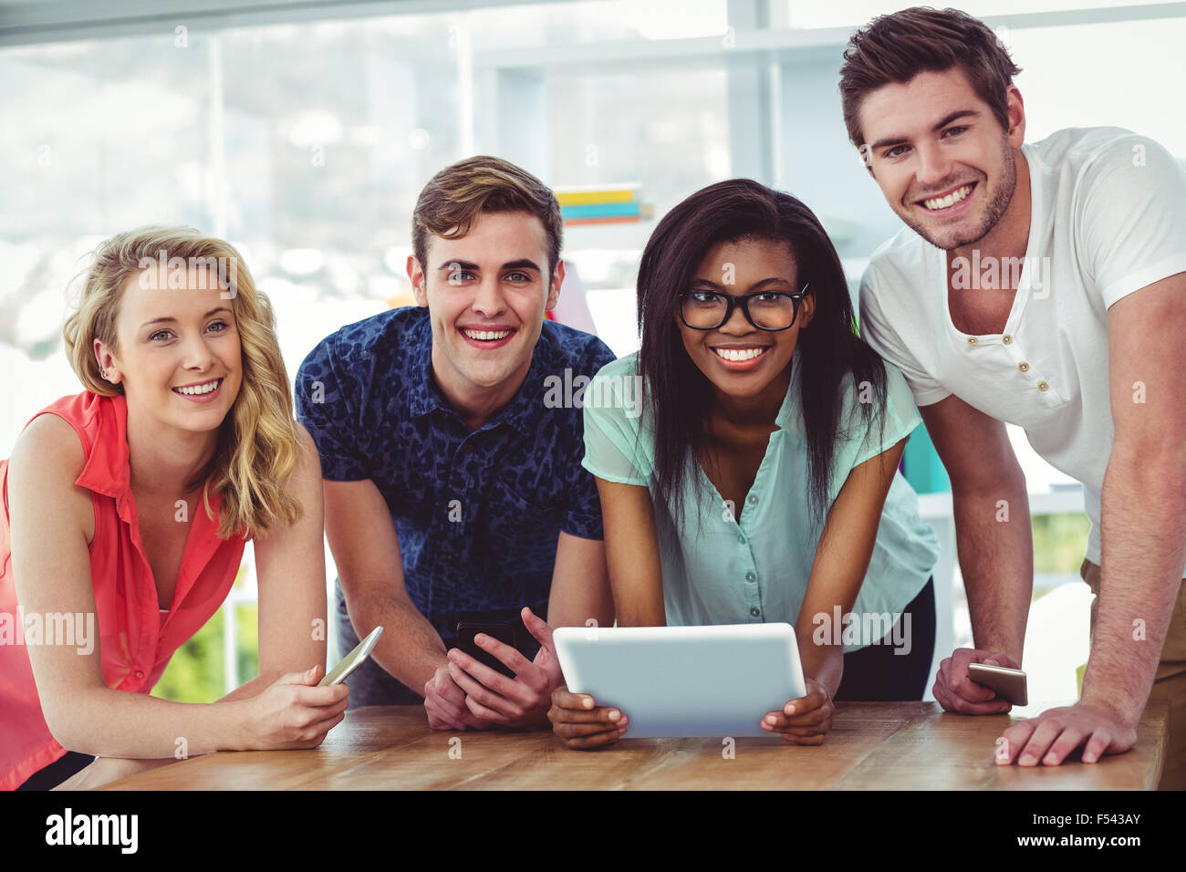 Creative team working together on a tablet Stock Photo - Alamy