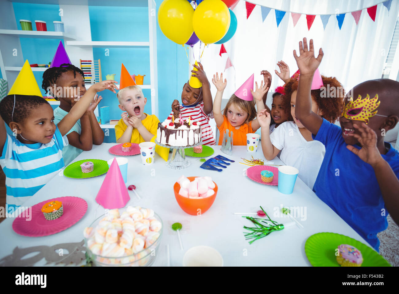 Excited kids enjoying a birthday party Stock Photo - Alamy