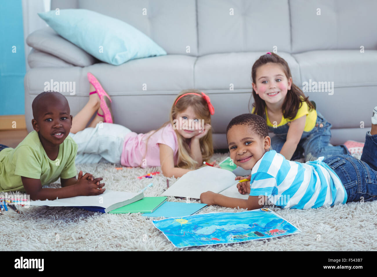 Smiling kids drawing pictures on paper Stock Photo - Alamy
