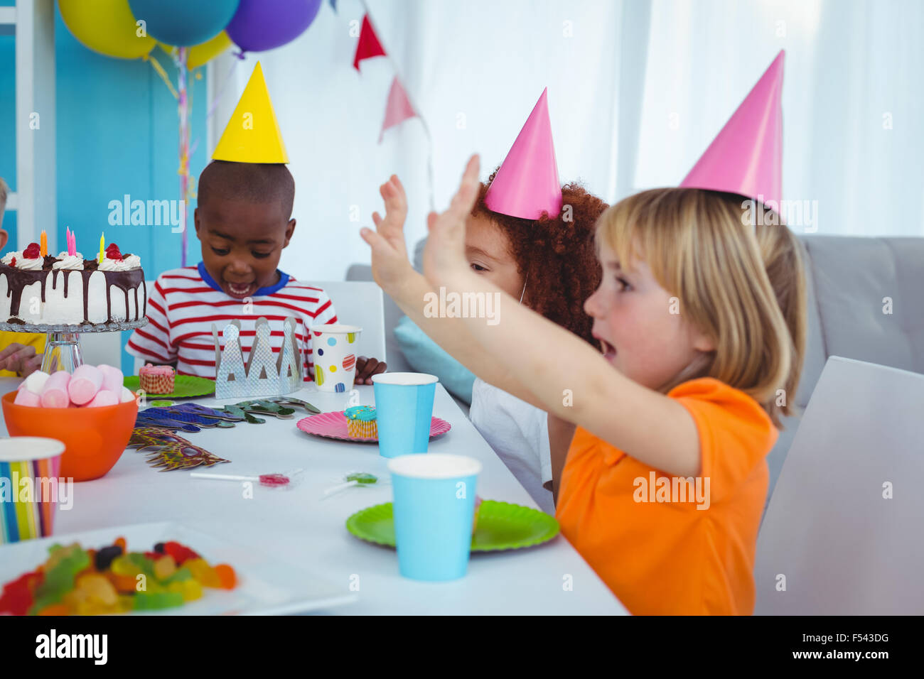Excited kids enjoying birthday party hi-res stock photography and ...