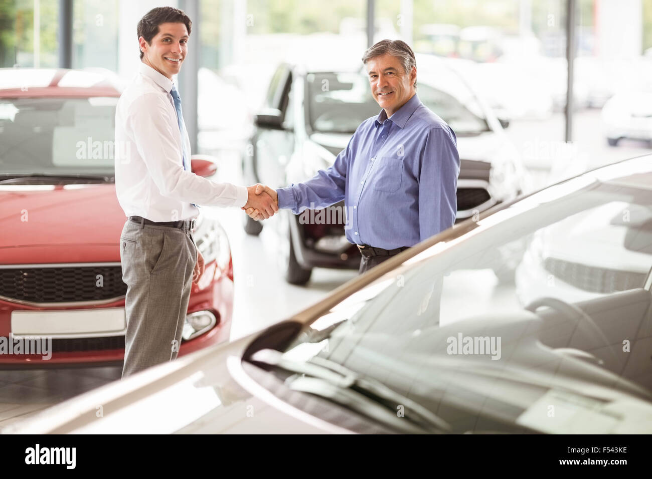Hand shaking customer hi-res stock photography and images - Alamy