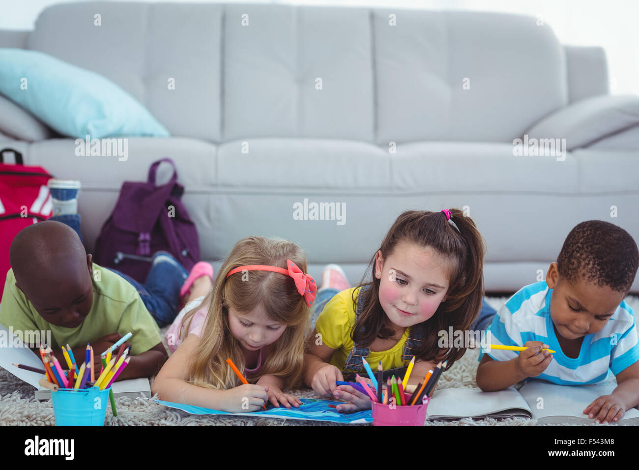 Smiling kids drawing pictures on paper Stock Photo - Alamy