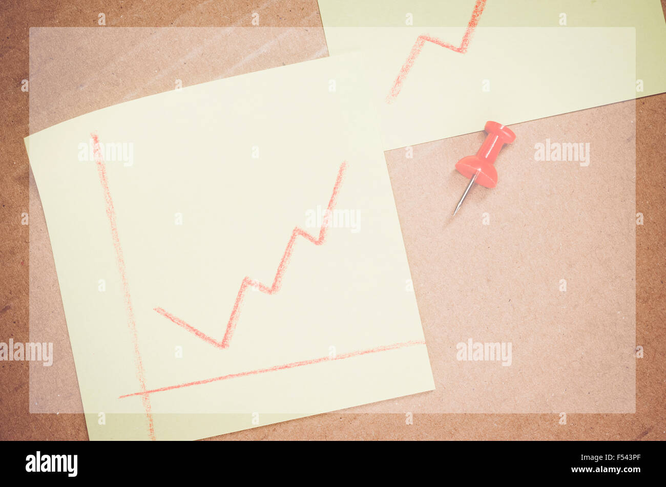 trand line graph on a yellow paper note - paperboard background with ...