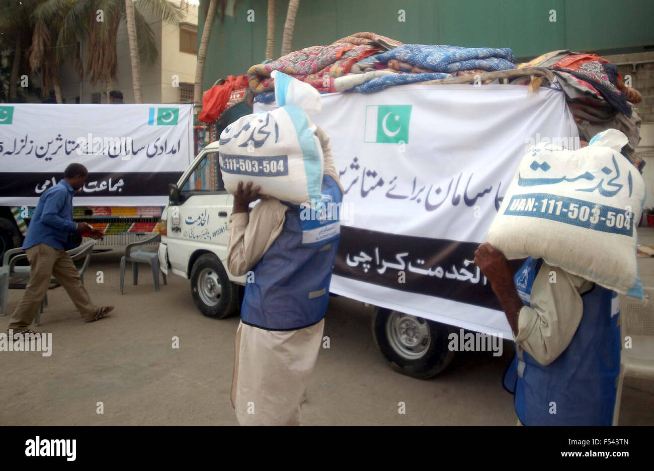 Volunteers of Al-Khidmat Foundation are loading relief good on trucks ...