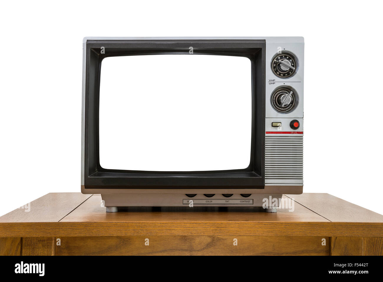 Vintage portable television and old wood table isolated on white with ...