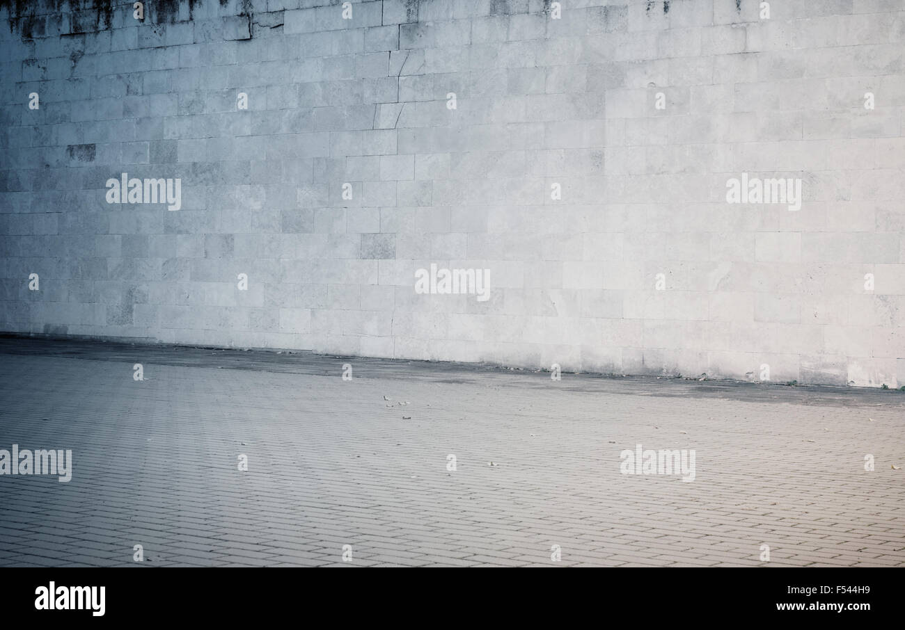 Weathered cinder block, brick wall texture with sidewalk Stock Photo ...