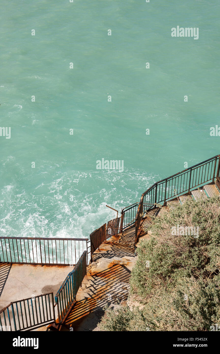 Stairs with rusty railing leading into turquoise water Stock Photo - Alamy