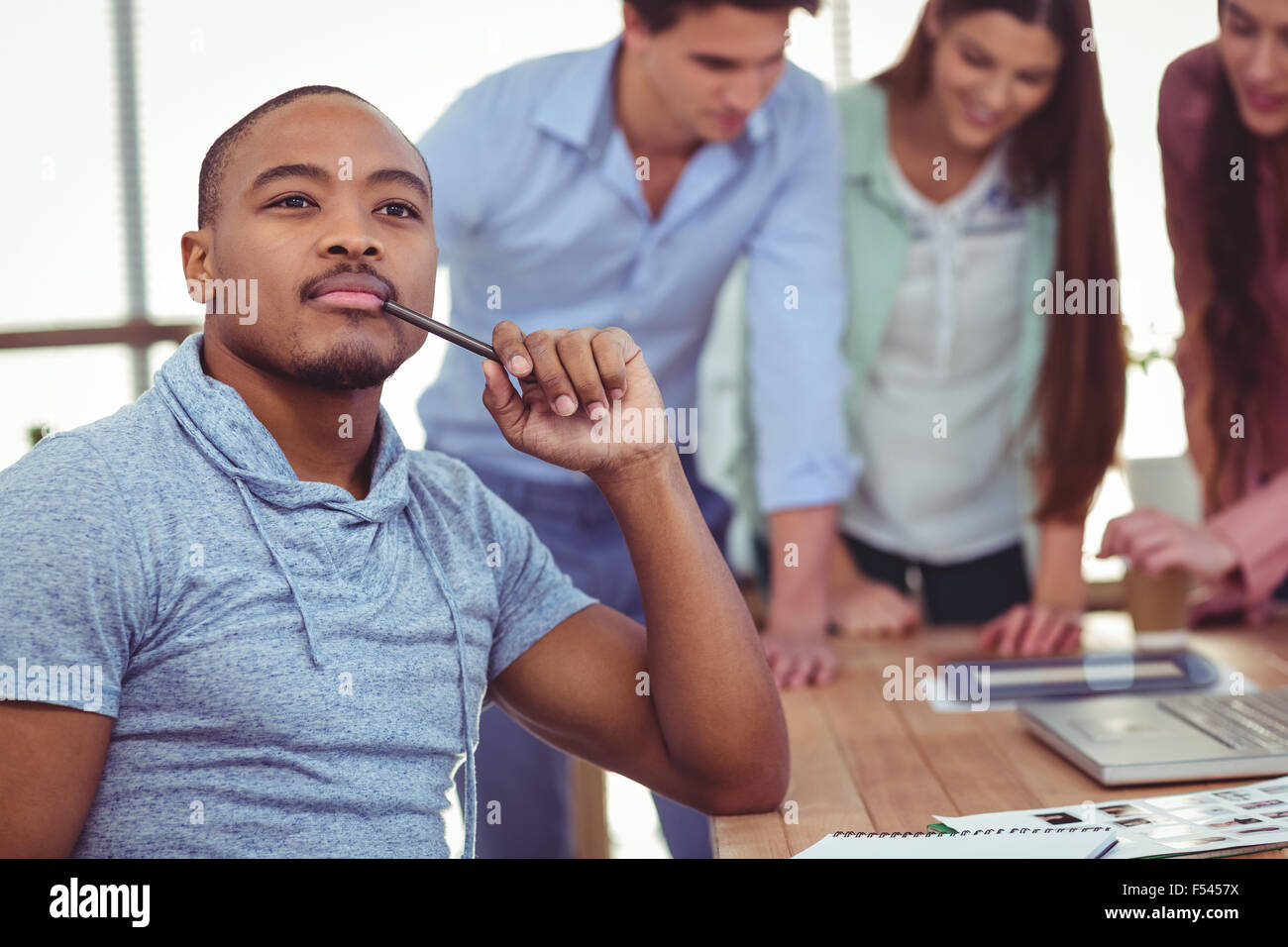 Young creative worker thinking Stock Photo - Alamy