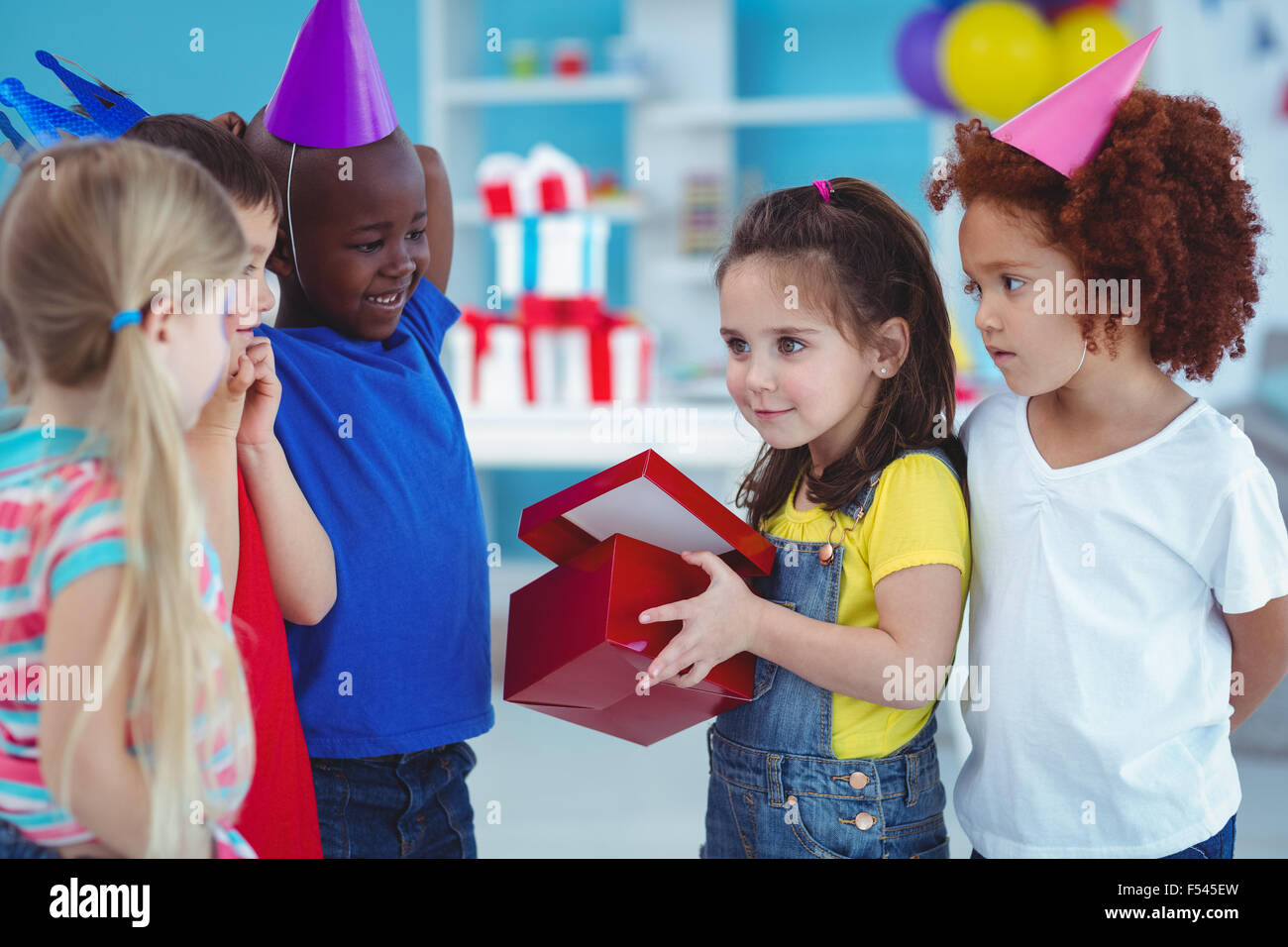 Happy girl opening a present Stock Photo - Alamy