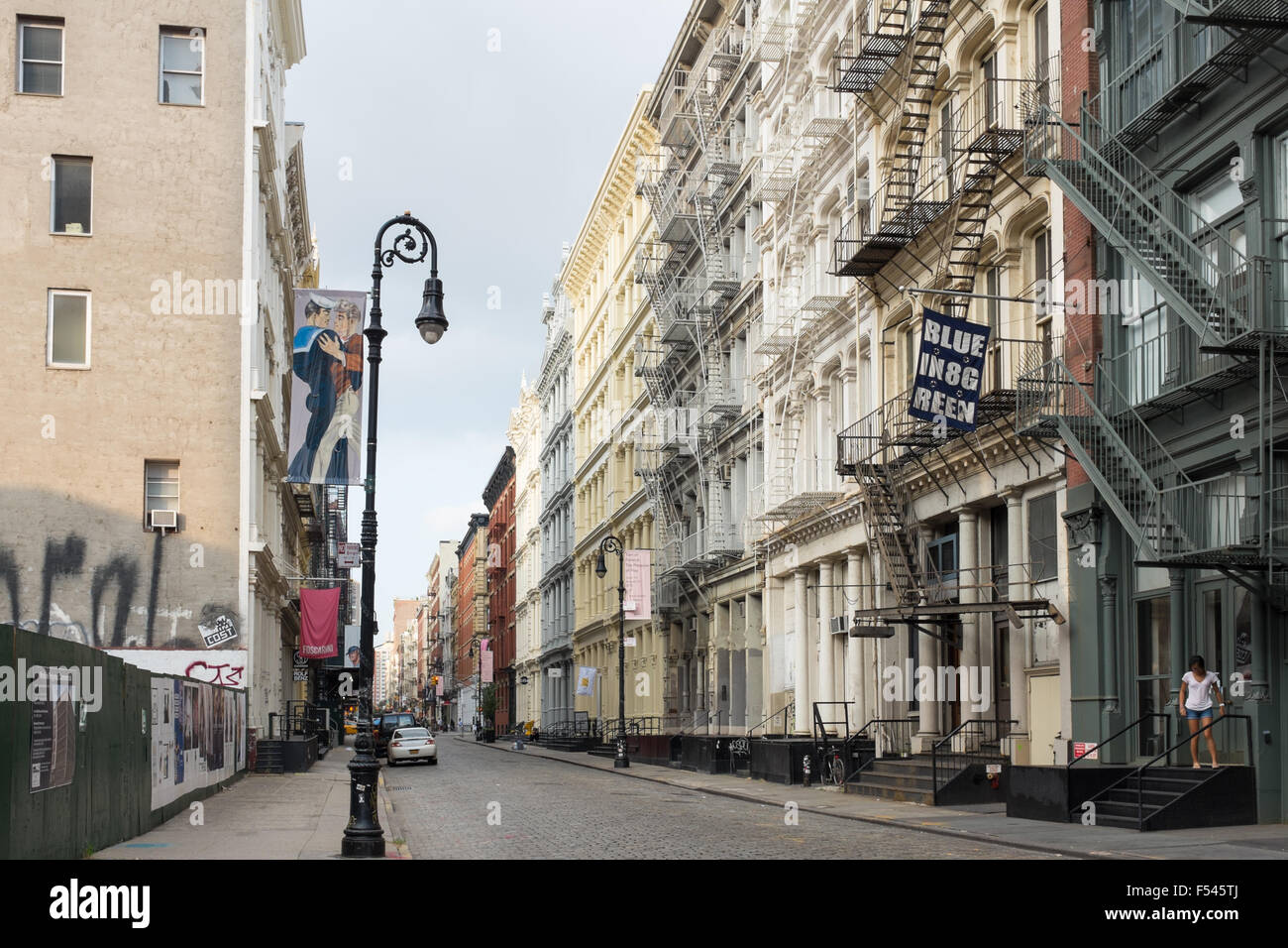 Narrow street lined by apartment blocks in Manhattan, New York, USA ...