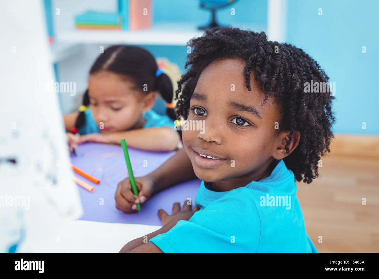 Children drawing on coloured paper Stock Photo - Alamy