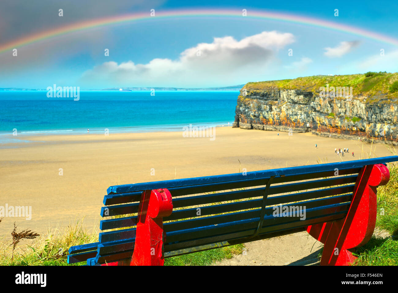 cliff walk bench overlooking the beautiful beach with rainbow in ...