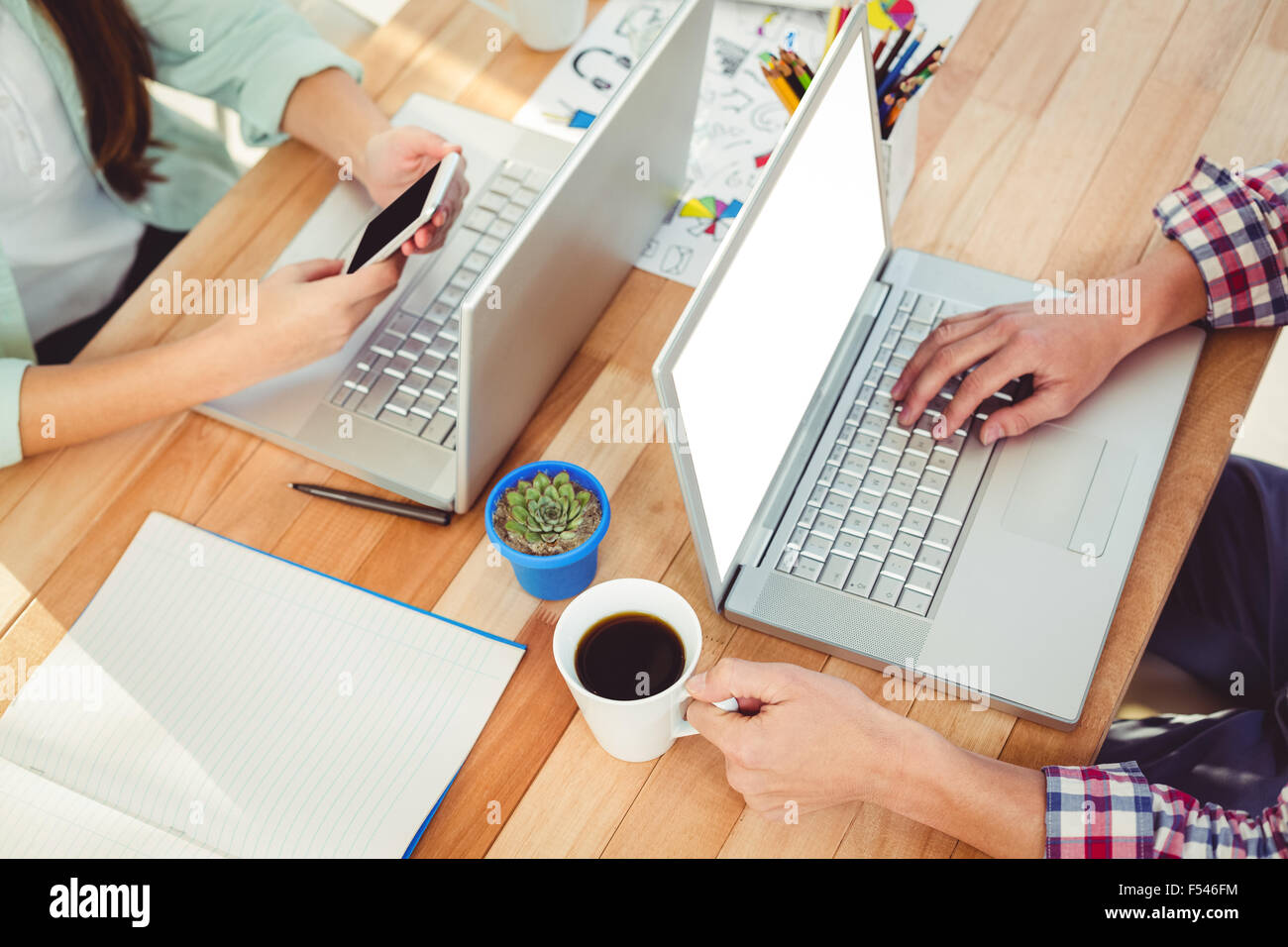 Creative team working together at desk Stock Photo - Alamy