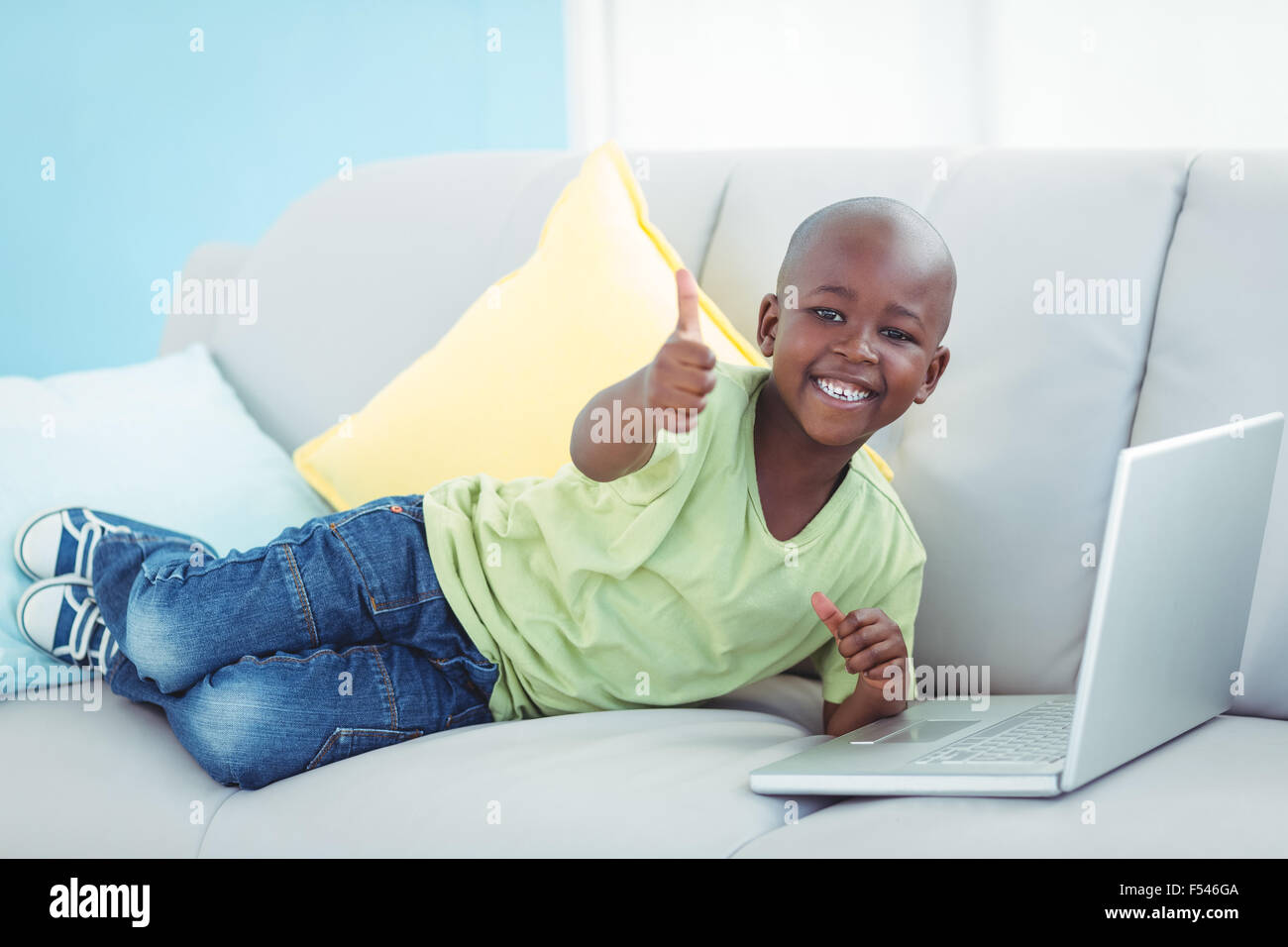 Happy boy using a laptop Stock Photo - Alamy