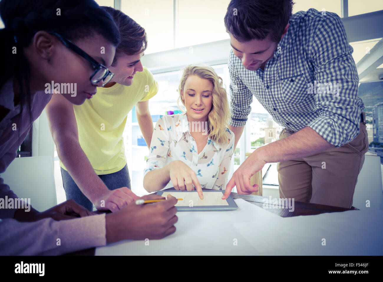 Creative business team working on a tablet together Stock Photo - Alamy