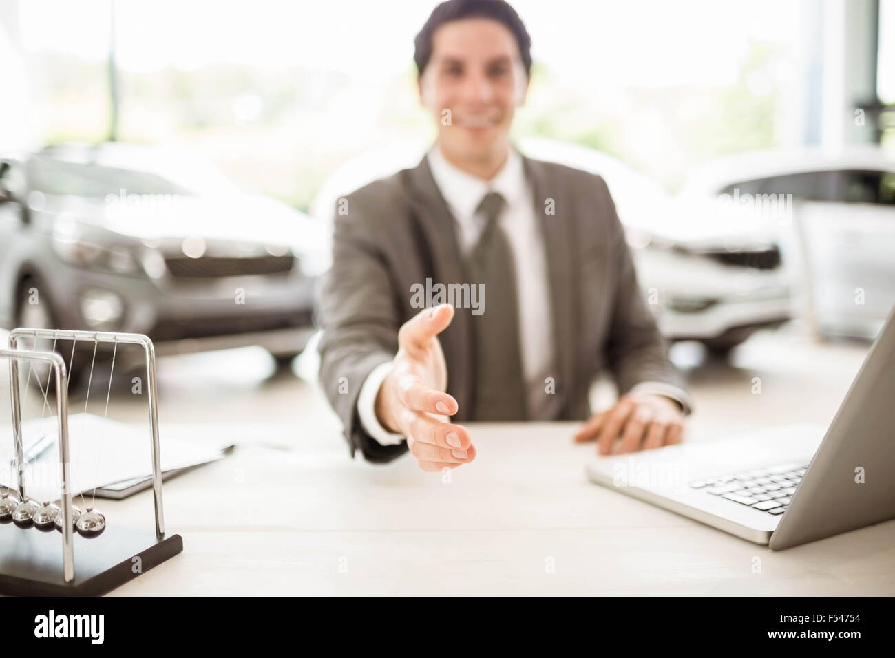 Smiling salesman ready to shake hand Stock Photo - Alamy