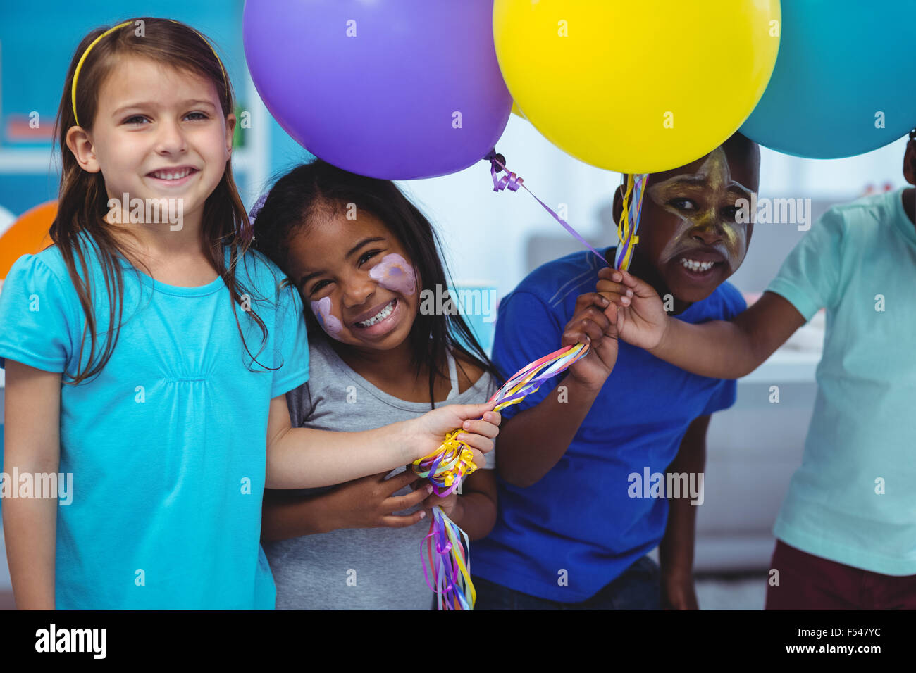 Happy kids playing with balloons Stock Photo - Alamy