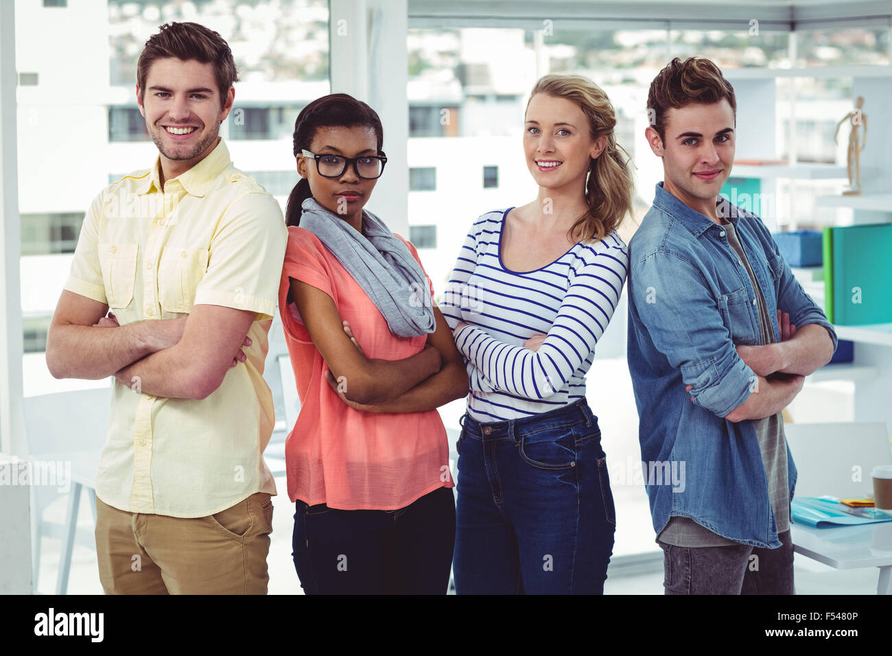 Happy creative team standing together Stock Photo - Alamy