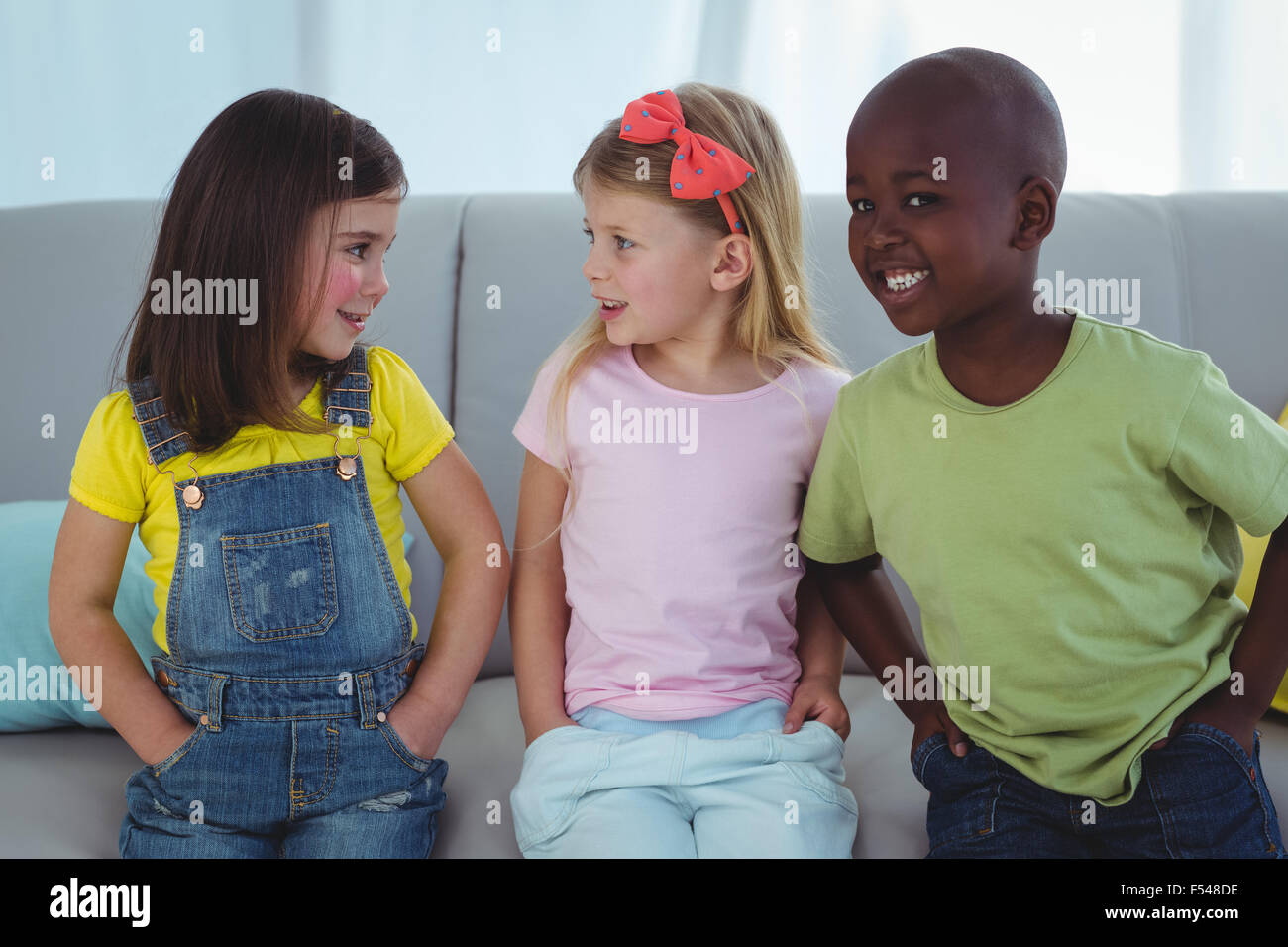 Happy kids sitting together Stock Photo - Alamy