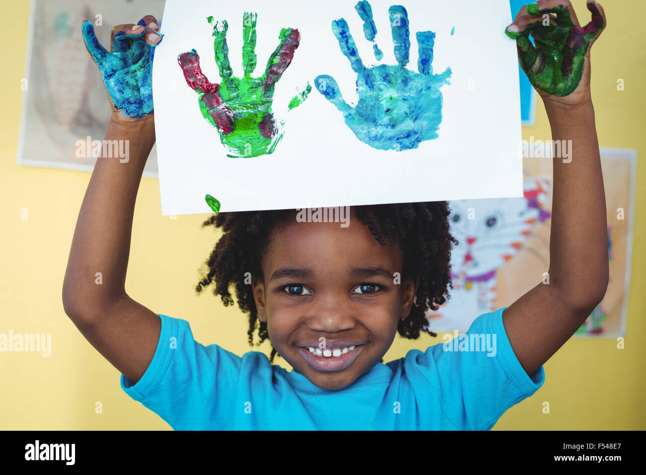 Smiling kid holding up his hands Stock Photo - Alamy