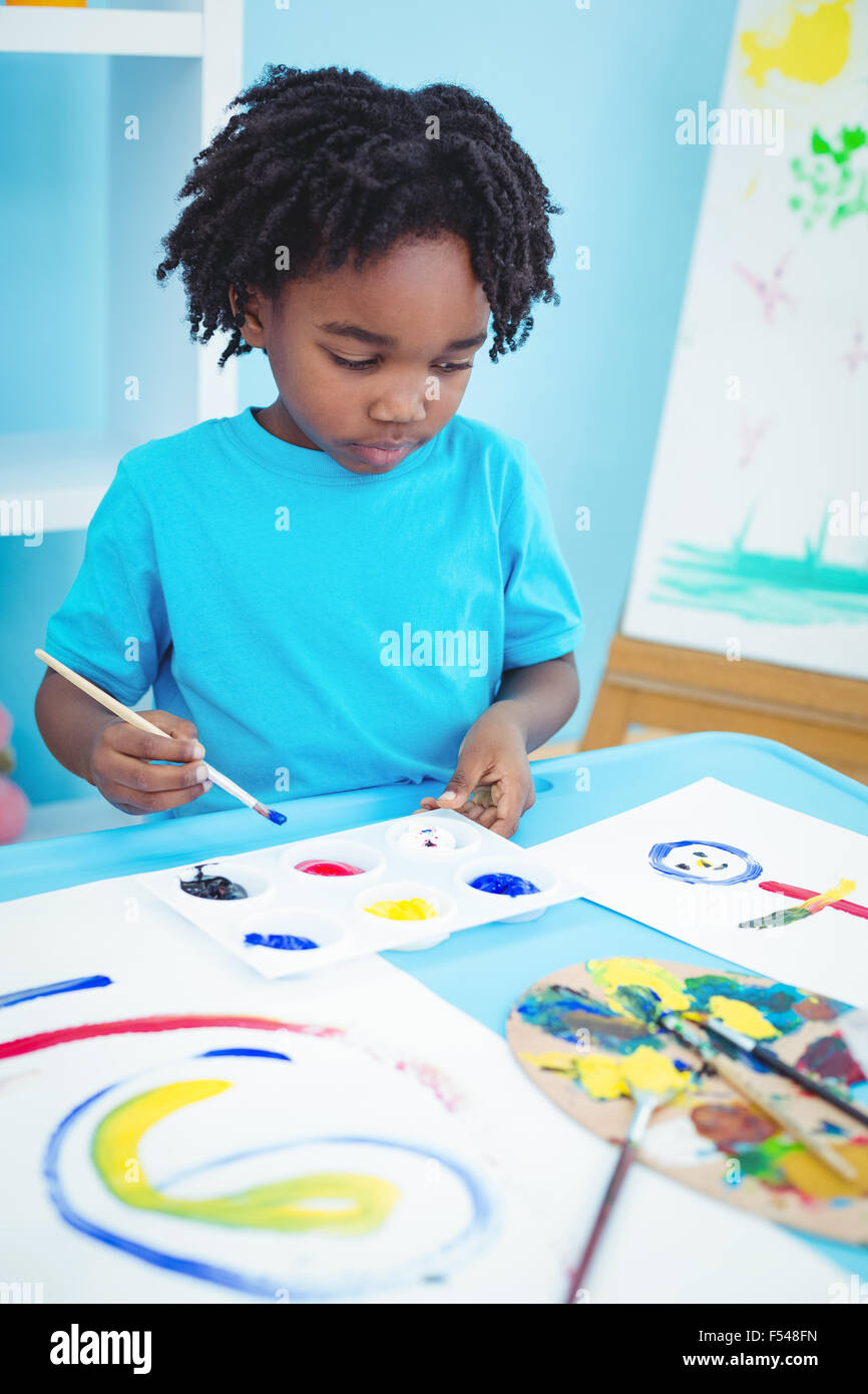 Happy kid enjoying arts and crafts painting Stock Photo - Alamy