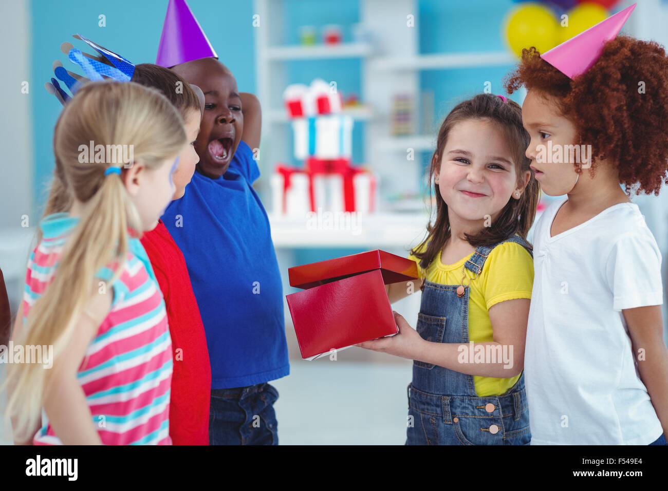 Happy girl opening a present Stock Photo - Alamy