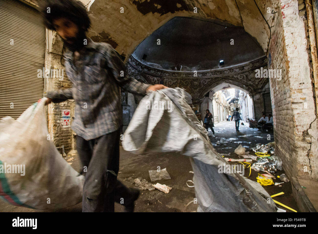 Worker carries sacks with garbage after closing Grand bazaar in Tehran ...